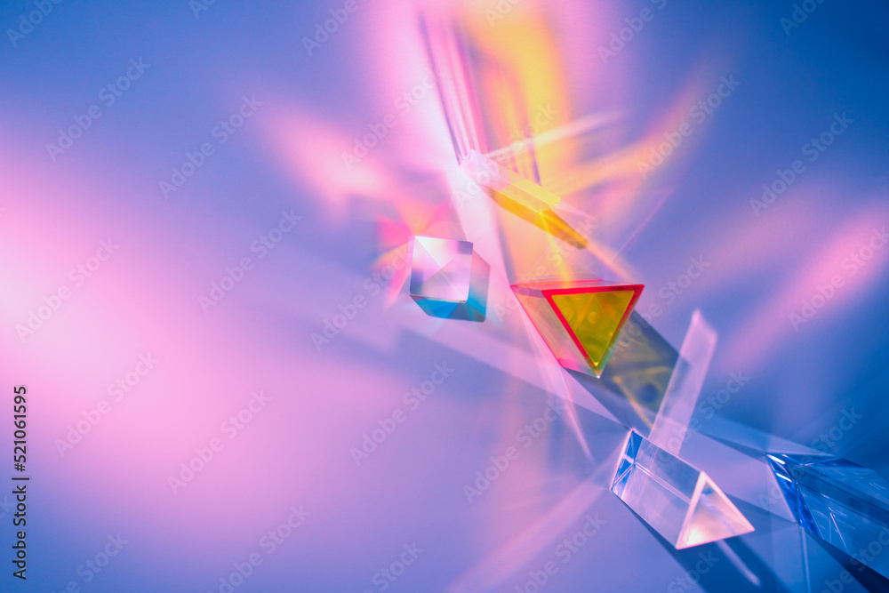 Glass prisms and cubes with color spectrum rays. Abstract background with reflection and ...
