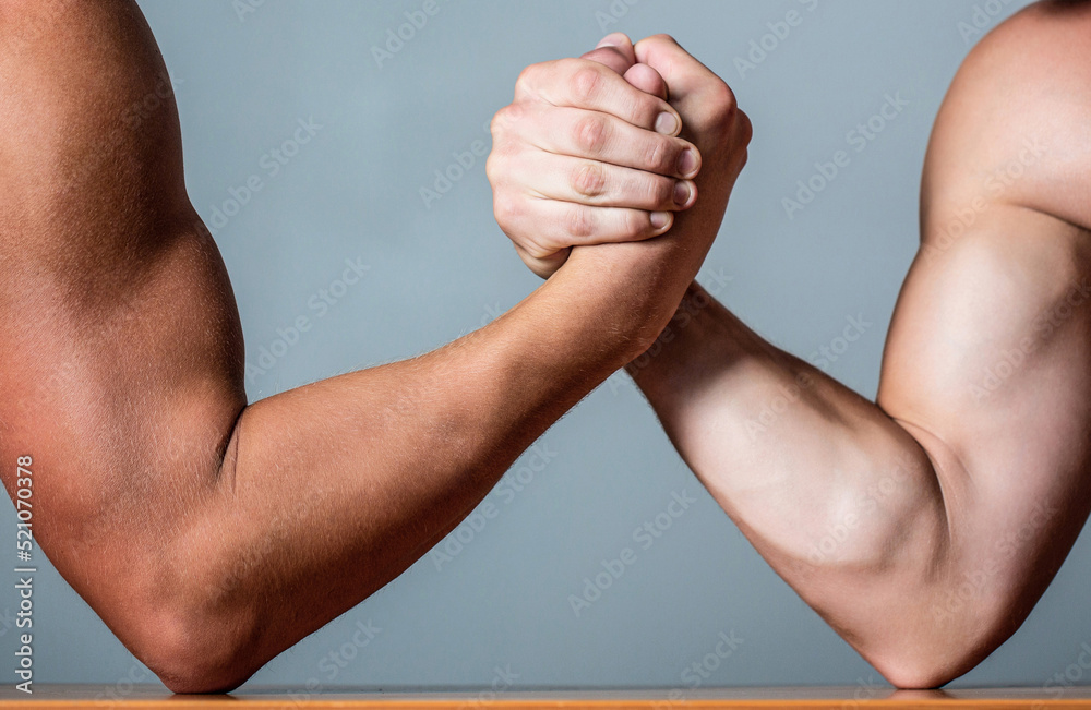 Rivalry, closeup of male arm wrestling. Two hands. Muscular men ...