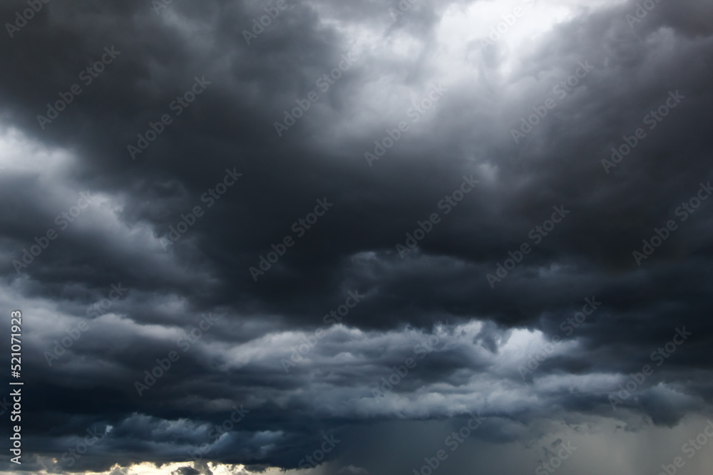 The dark sky with heavy clouds converging and a violent storm before ...