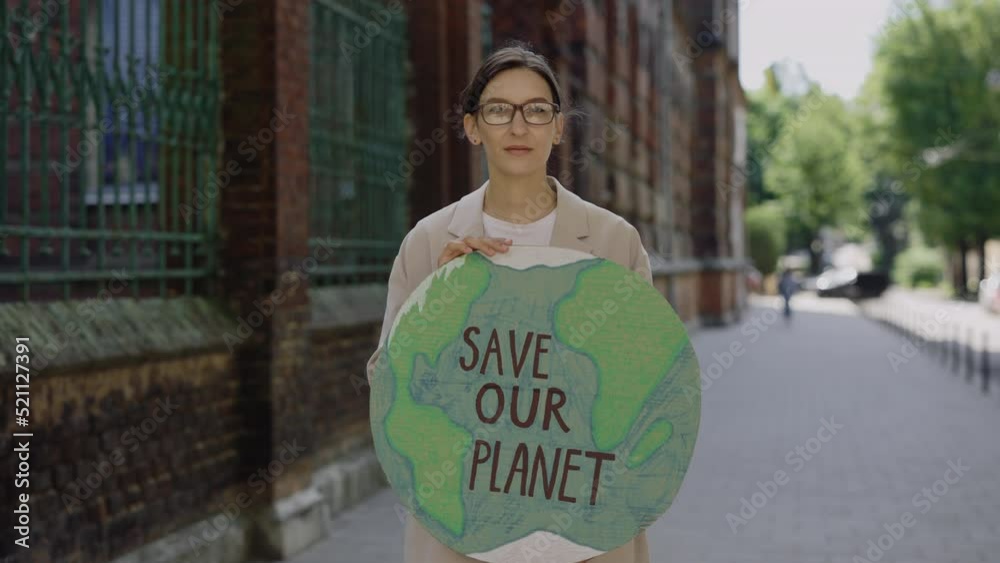 Single female eco activist standing and holding banner save our planet ...