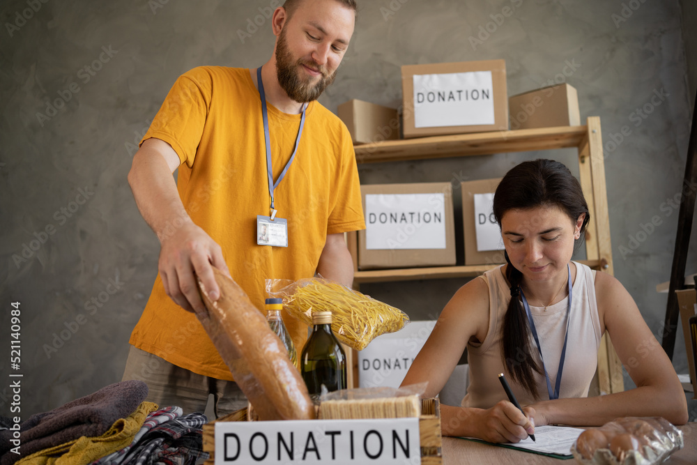 Group of volunteers working in community charity donation center ...