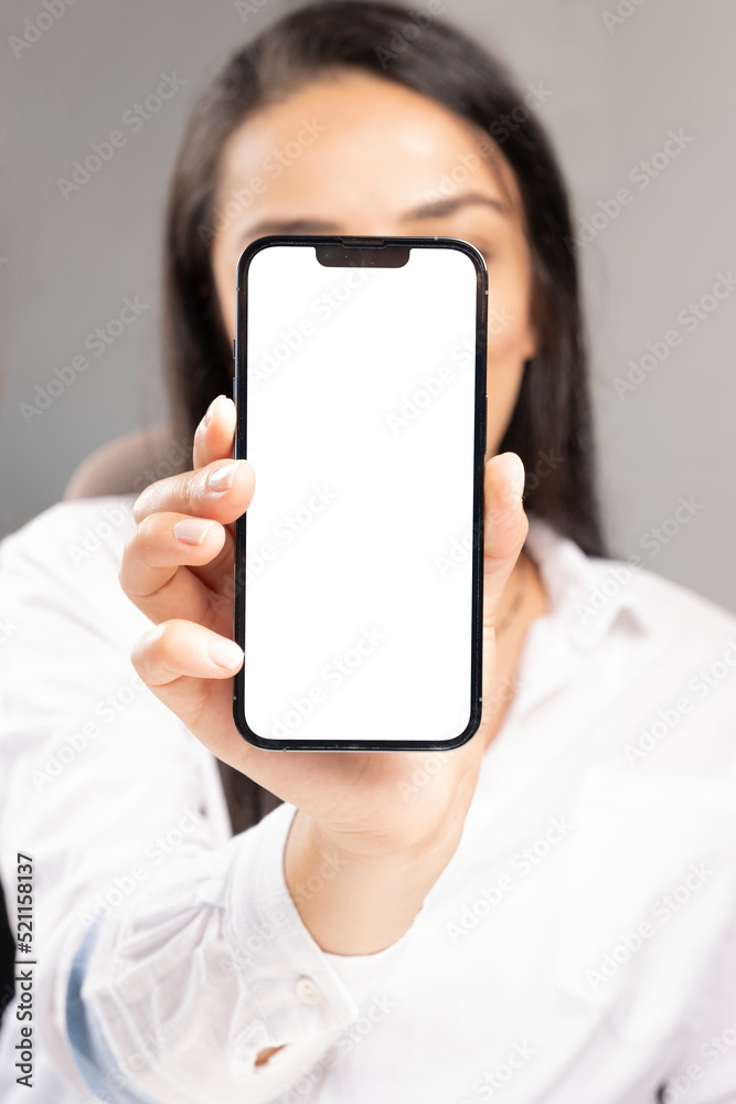 Holding smartphone, young woman holding smartphone in front of her face ...