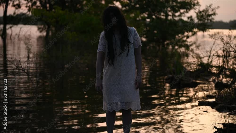 Portrait of asian woman make up ghost face at the swamp,Horror in water ...