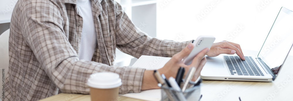 Young student does his homework and is broadcast live on his laptop ...