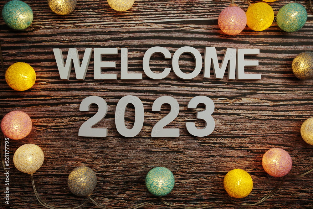 Welcome 2023 alphabet letters decorate with LED cotton balls on wooden ...