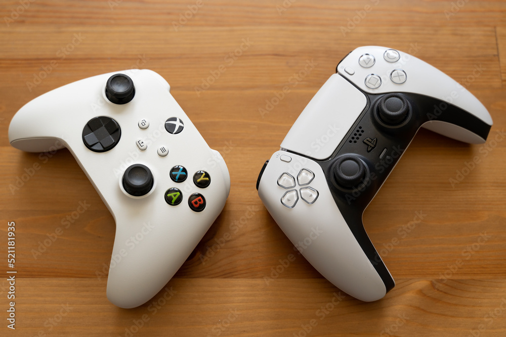 Xbox Series S and Playstation 5 controllers forming a V Stock Photo ...
