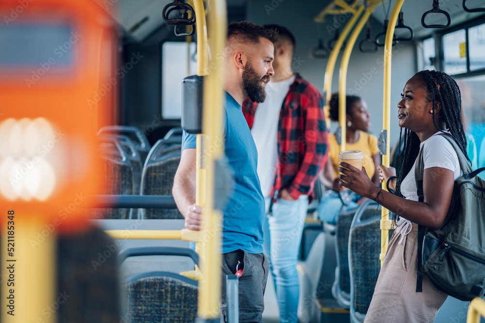 Multiracial friends talking while riding a bus in the city Stock Photo ...