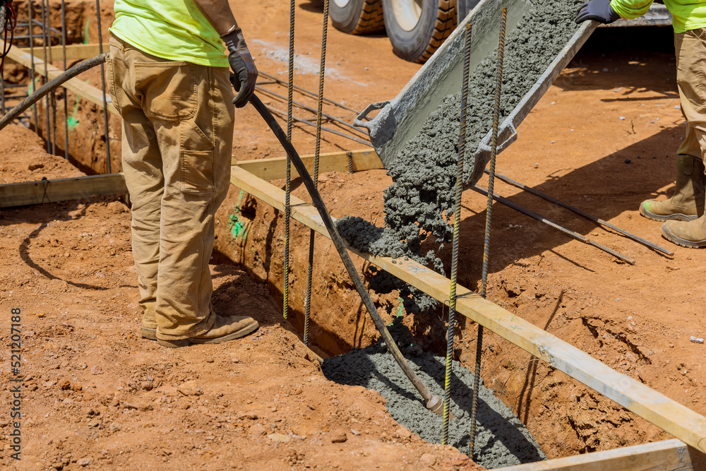 Building house through the pouring of concrete trenches on top a solid ...