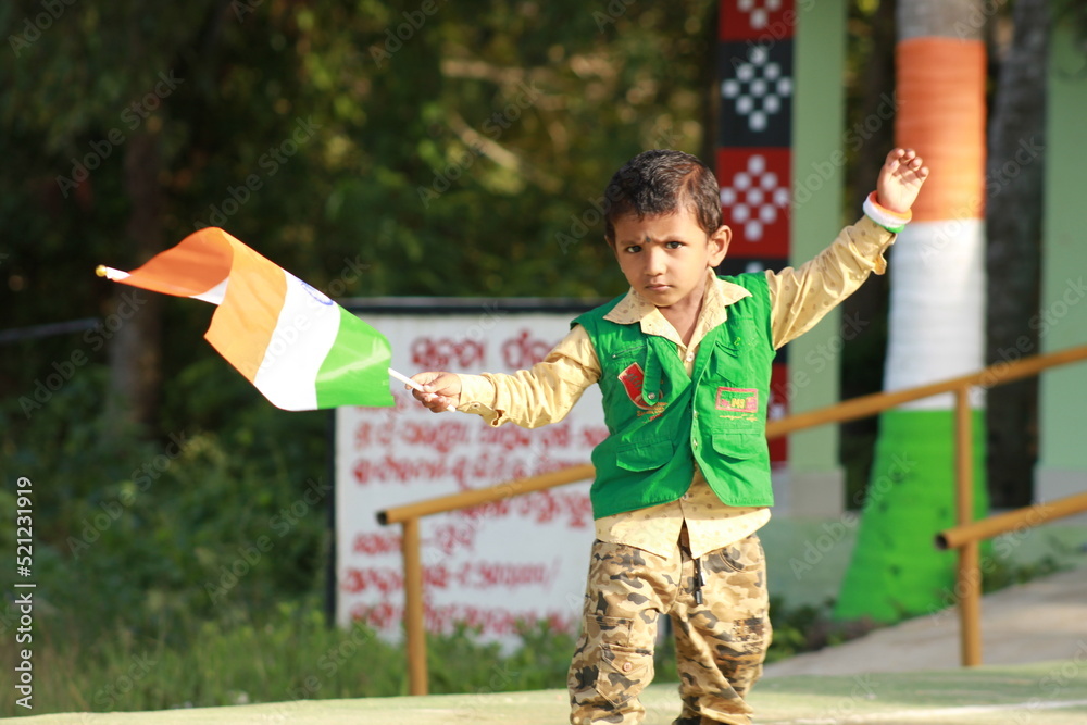 little indian boy proudly holding Indian National flag. The national ...