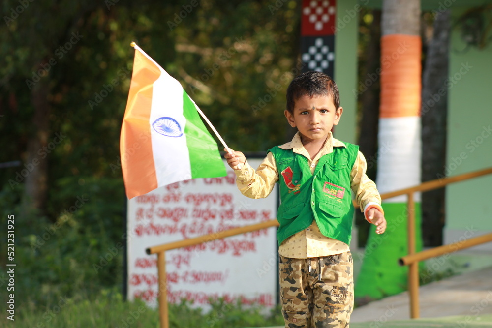 little indian boy proudly holding Indian National flag. The national ...