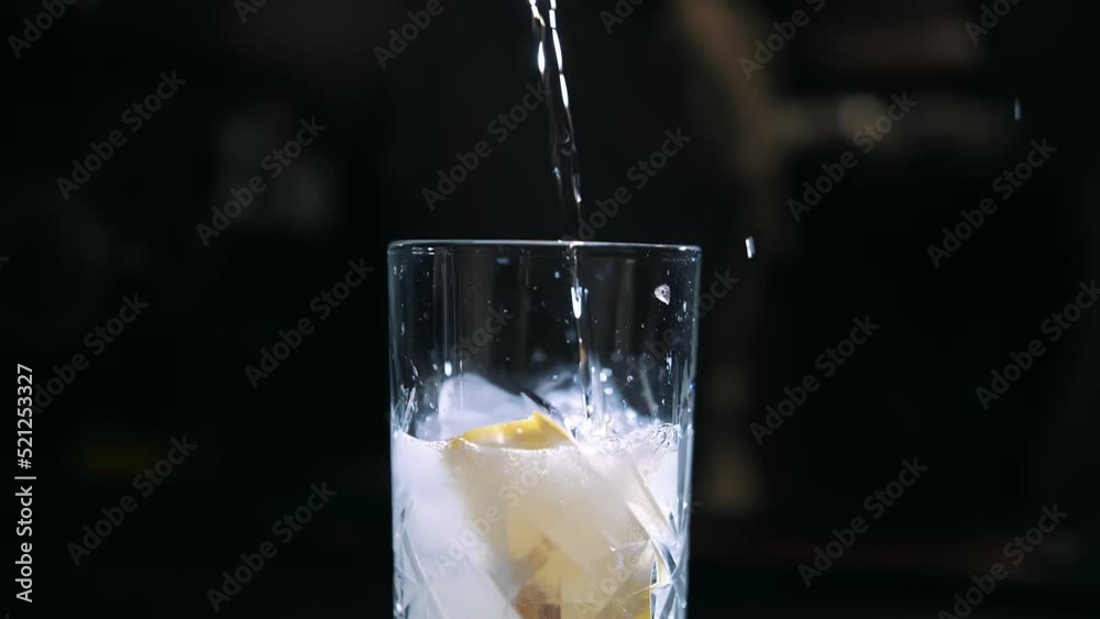 cocktail. soda bubbles. making cocktail. close-up. Bartender gently pours transparent bottled ...
