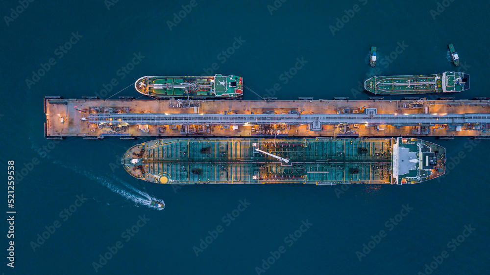 Aerial view tanker ship vessel unloading at port at night, Global ...