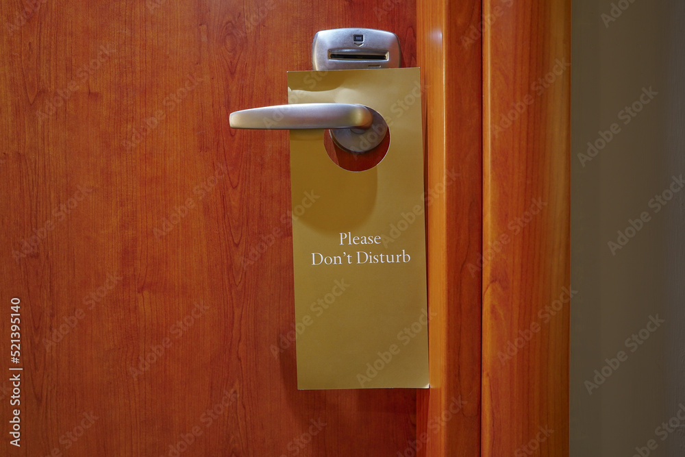 Wooden hotel door with the sign hang does not disturb. Do Not Disturb ...