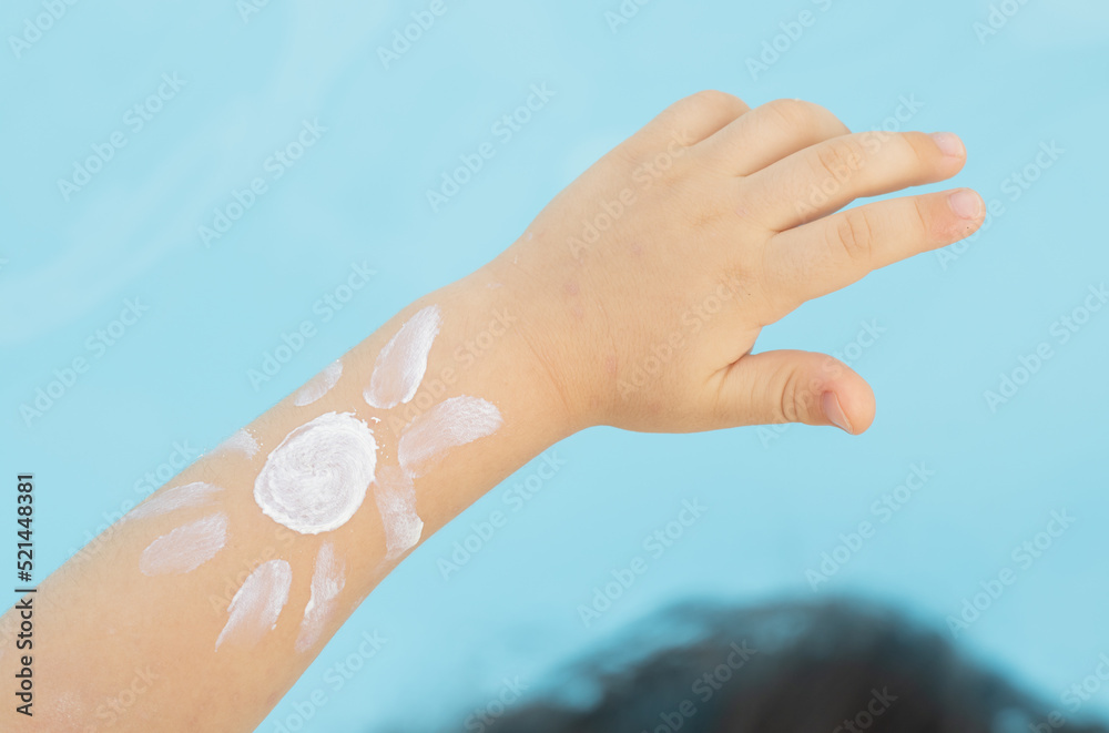 cute little baby hand and sun shape drawn with protective cream,pool ...