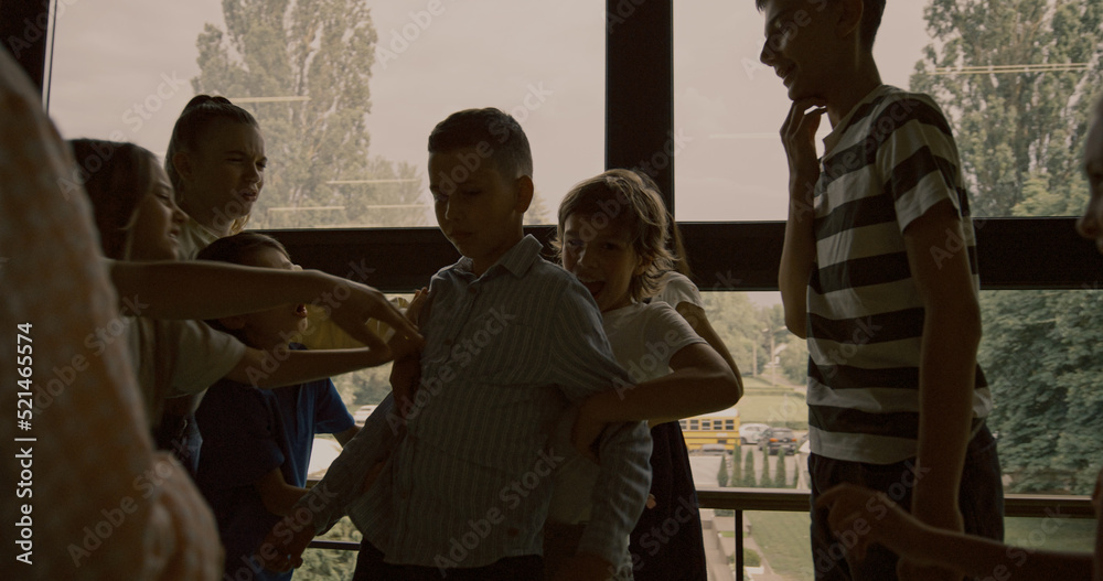 Aggressive students pushing conflict victim in hallway. Bullies ...