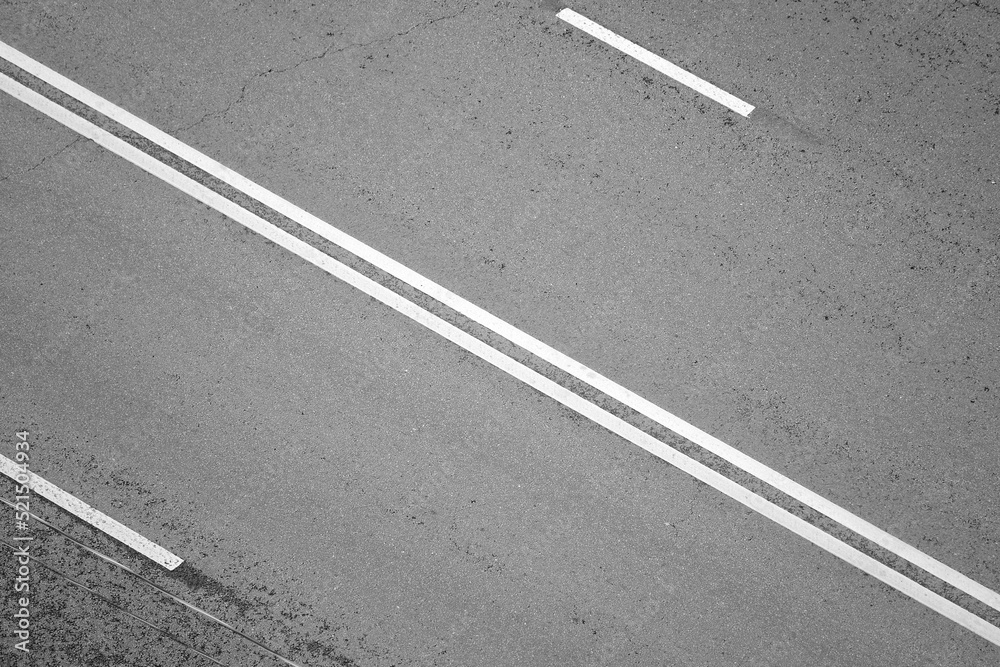 surface of asphalt driveway with road markings two solid lines ...