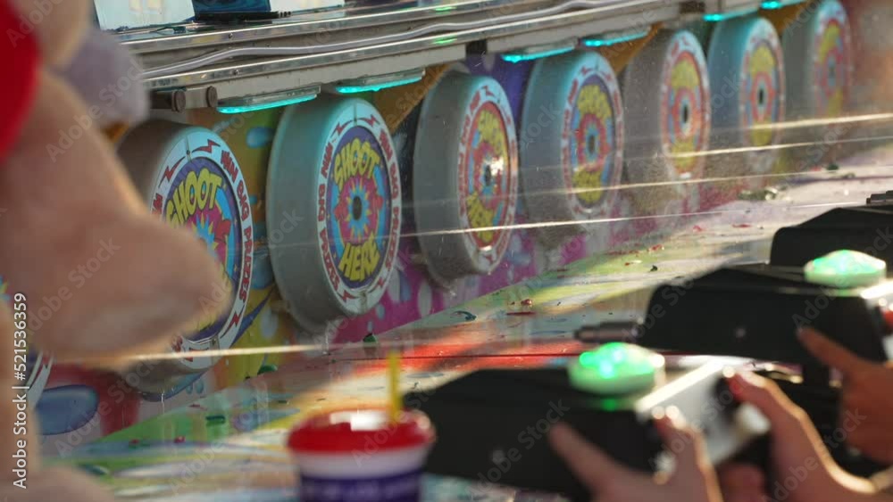 This video shows a close up, side view of water gun games as players ...