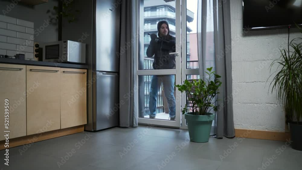 Burglar robber break door lock and entering building apartment. house ...