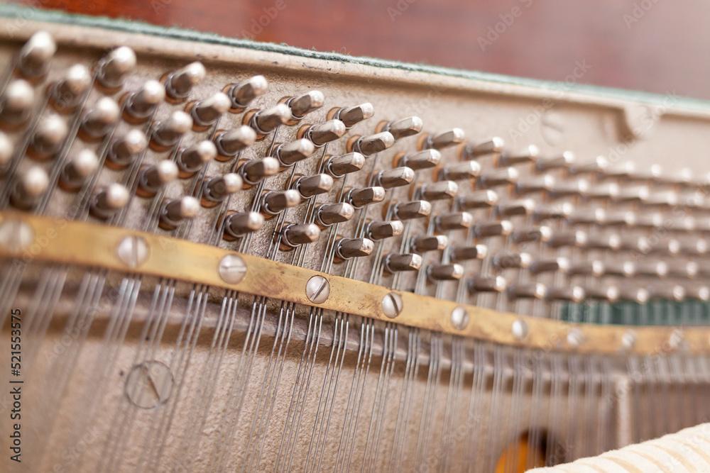 The inside of the piano is without a lid. Strings, hammers and other ...