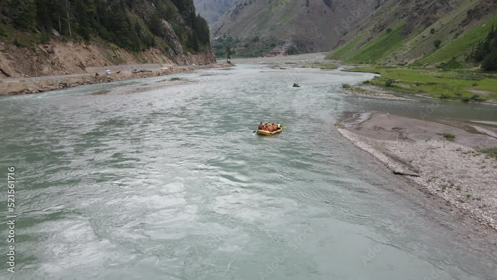 Drone flying over Kunhar river while tourists enjoy river rafting in ...