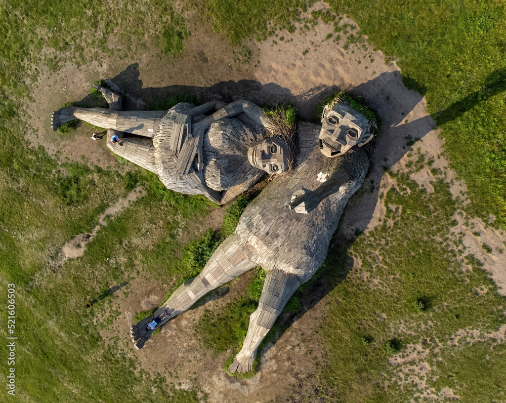 People standing on Giant wooden troll sculptures Una and Joures by ...