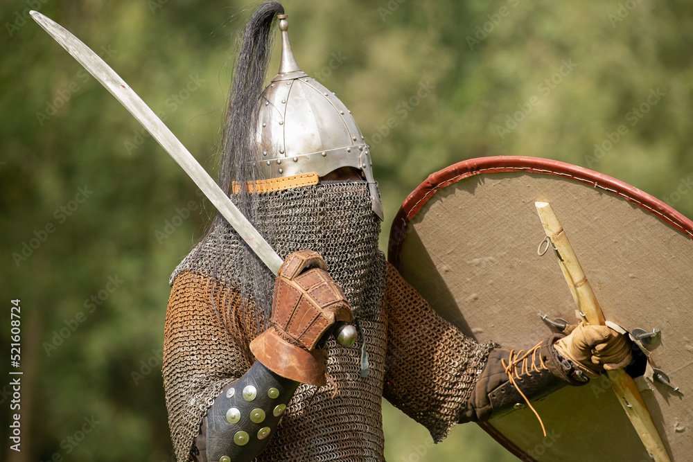 medieval soldier knight in armour chain mail coif holding sword and ...