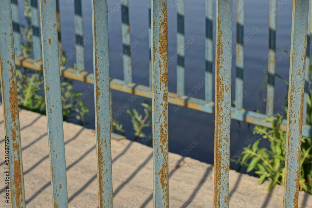 blue metal texture of iron rods and brown rust on a background of green ...