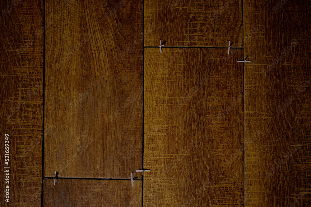 Laying ceramic tiles with the help of crosses for a tile by during wall ...