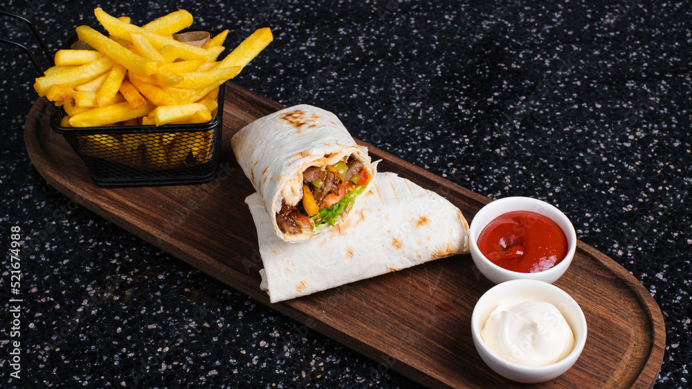 Beef durum kebab with french fries basket and ketchup. Beef lavash ...