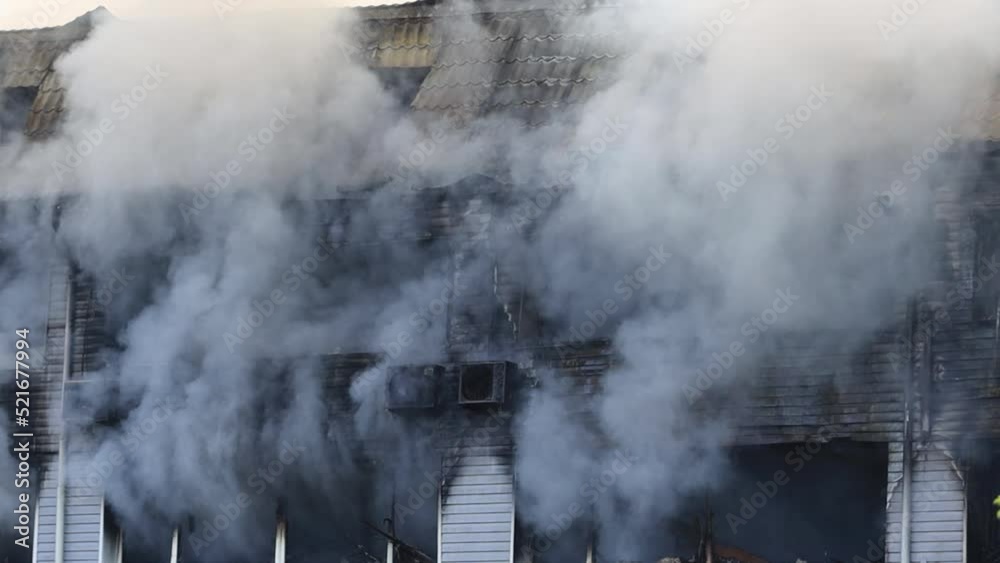 Thick gray smoke from the windows without glass of an industrial ...
