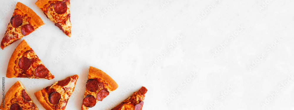 Pepperoni pizza slice corner border. Above view over a white marble ...