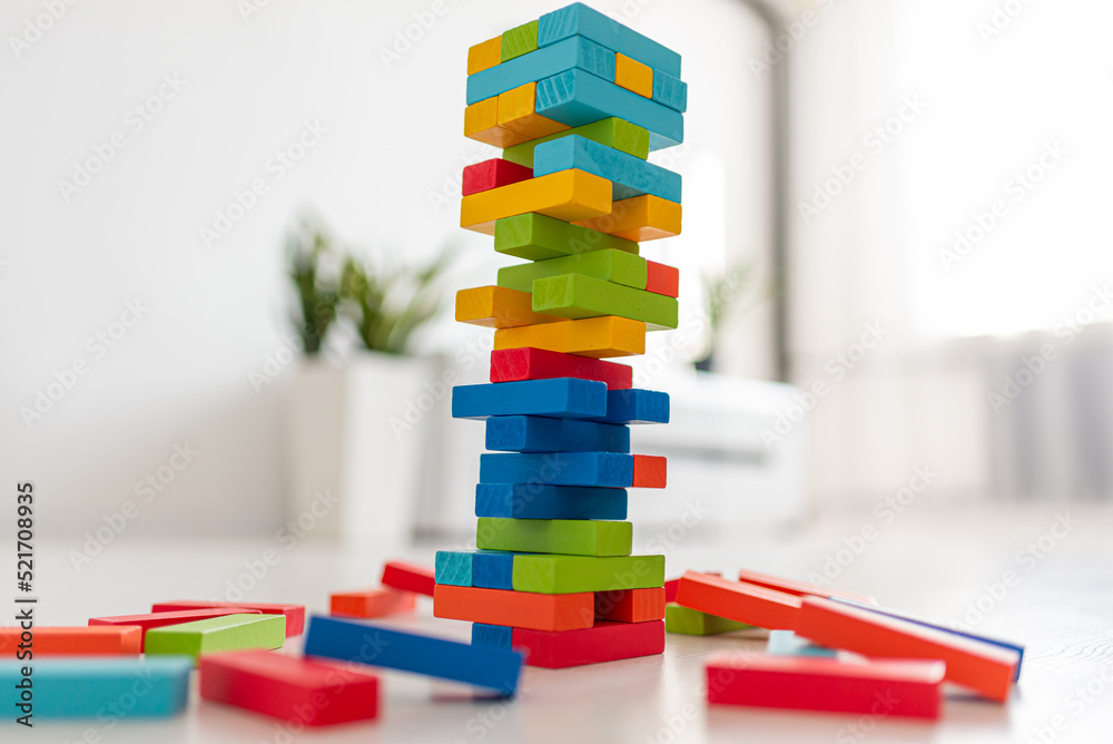 Board game Tower made of wooden blocks. A tower of unevenly shifted ...