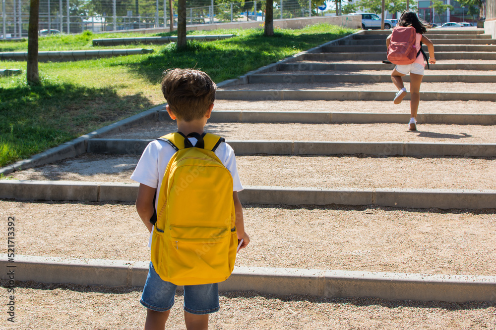 Elementary age children running out of school. Girl and boy playing ...