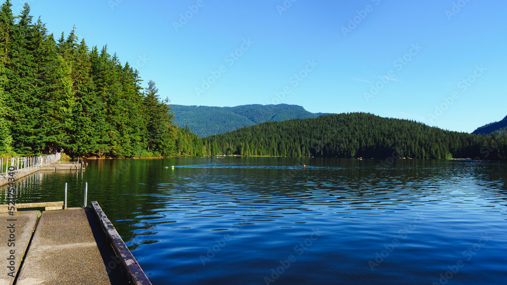 Lovely Sasamat Lake in Belcarra Regional Park, with mountain backdrop ...