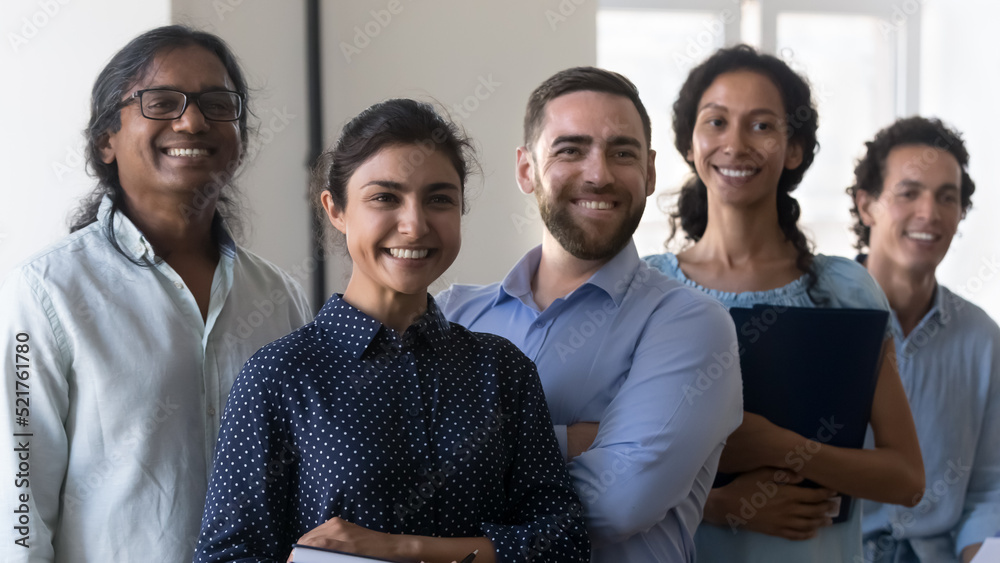 Multi racial company members, enthusiastic business people smile pose ...