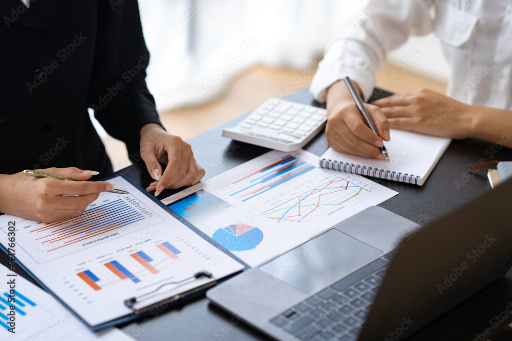 Business adviser analyzes financial figures by checking documents ...