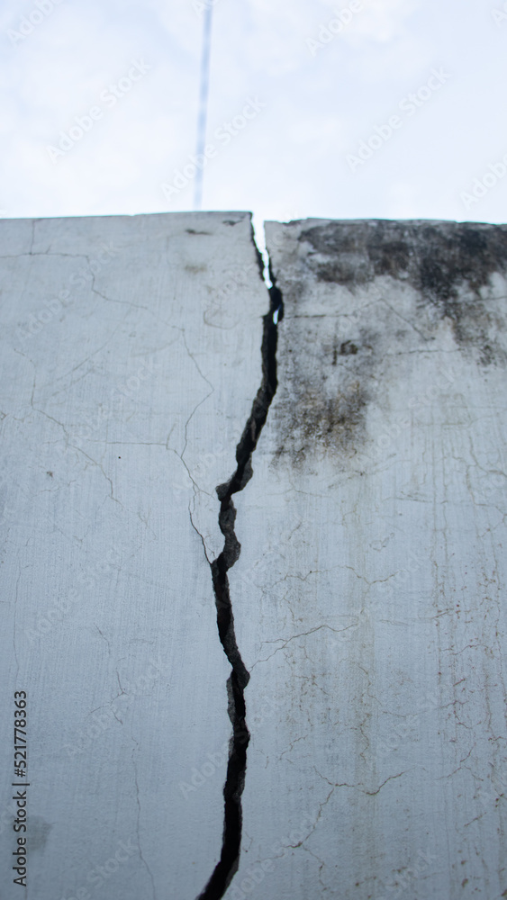 Cracked concrete building broken wall at the outside cement corner that ...
