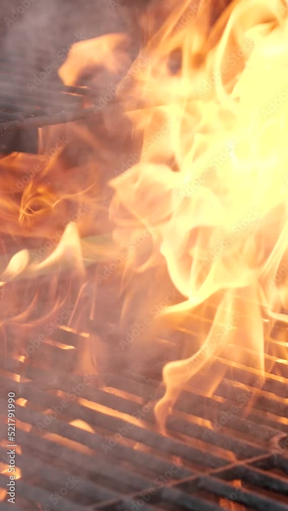 Vertical barbecue grill, slow motion bbq fire flame burning, cooking ...