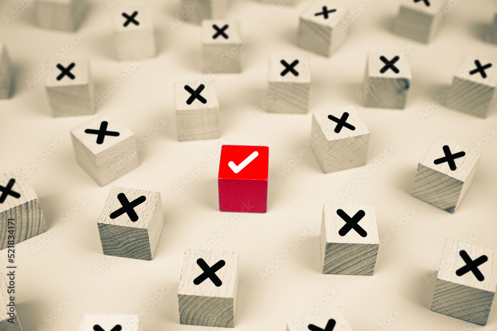 Check mark on cube wooden toy block with cross symbol for true or false ...