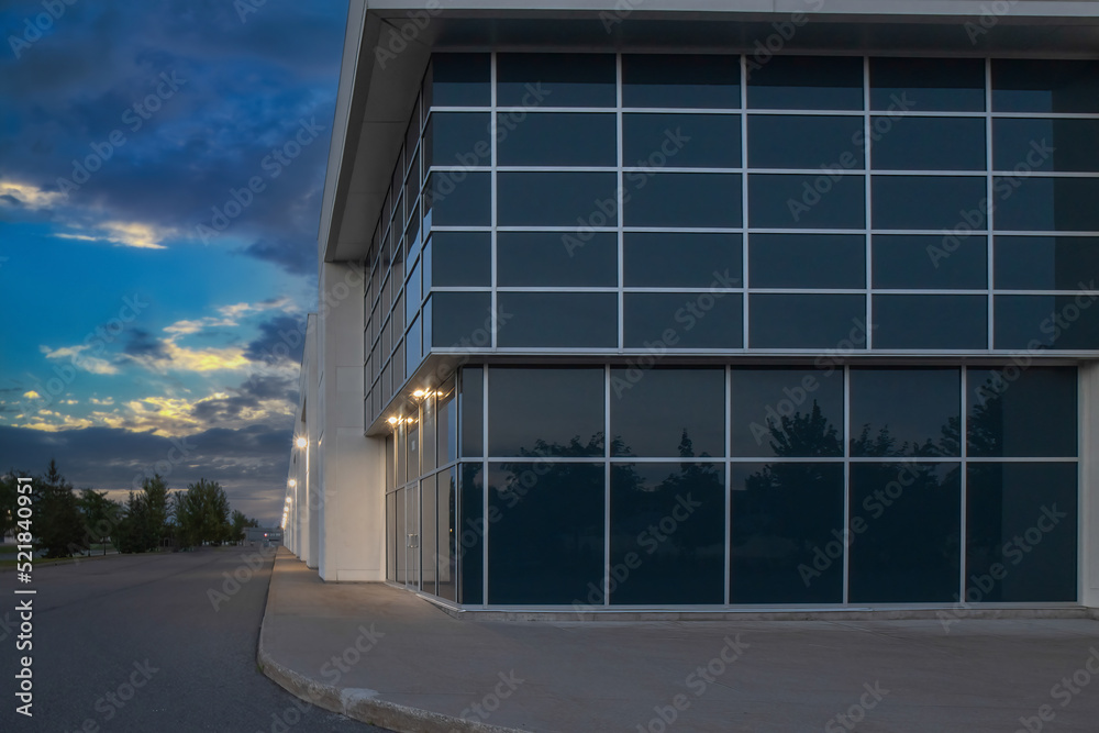 Exterior view of a generic business park building at dusk with multiple ...
