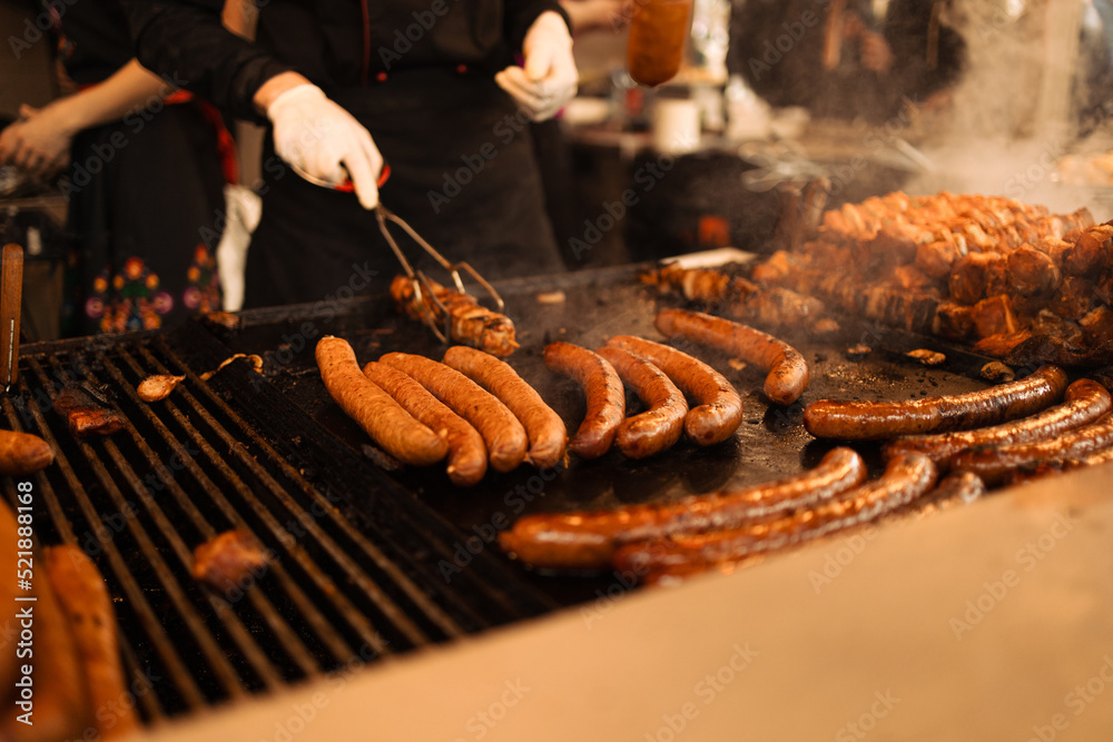 Blurry background of bbq street food for sale. Fried baked sausages ...