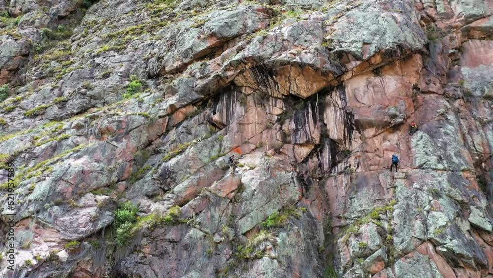 Drone shots of climbers at the Urubamba cliffs in Cusco, Peru. It is ...