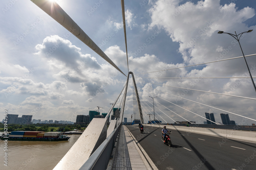Wide angle view with traffic and boat of Thu Thiem Two Bridge crossing ...