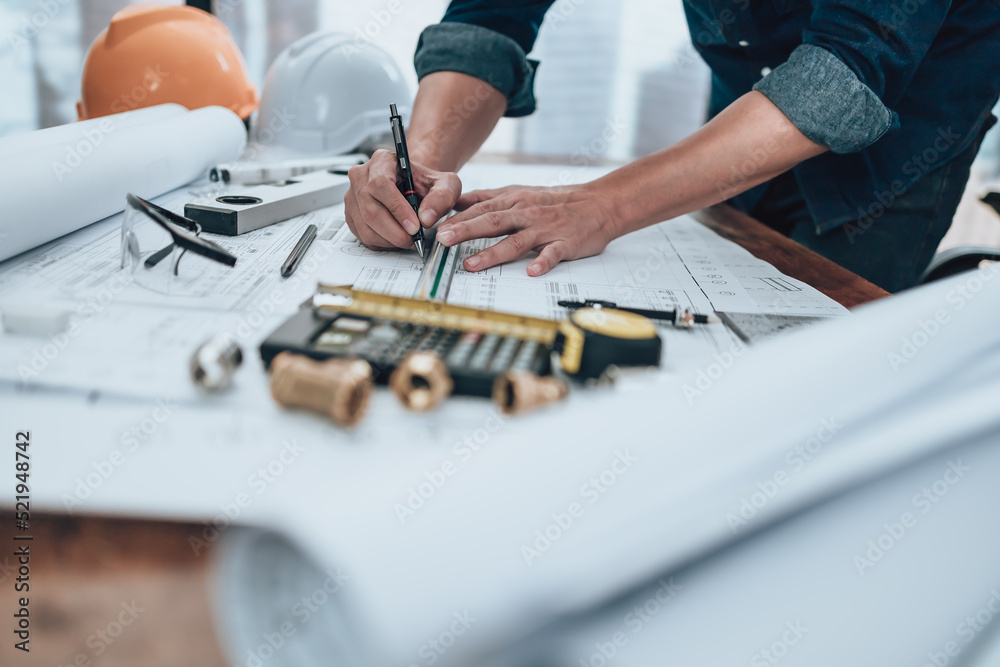 Engineering working with drawings inspection and writing on the office ...