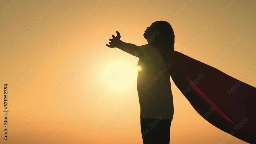 girl superhero with long hair red cape wind sunset. brave superhero ...