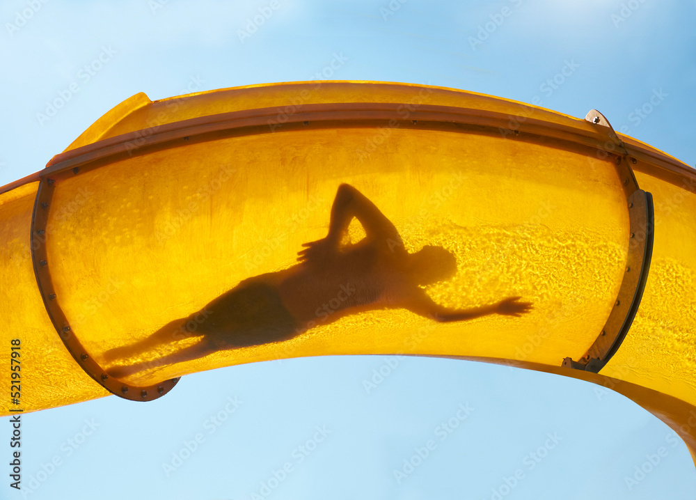 Silhouette of person sliding down water slide Stock Photo | Adobe Stock