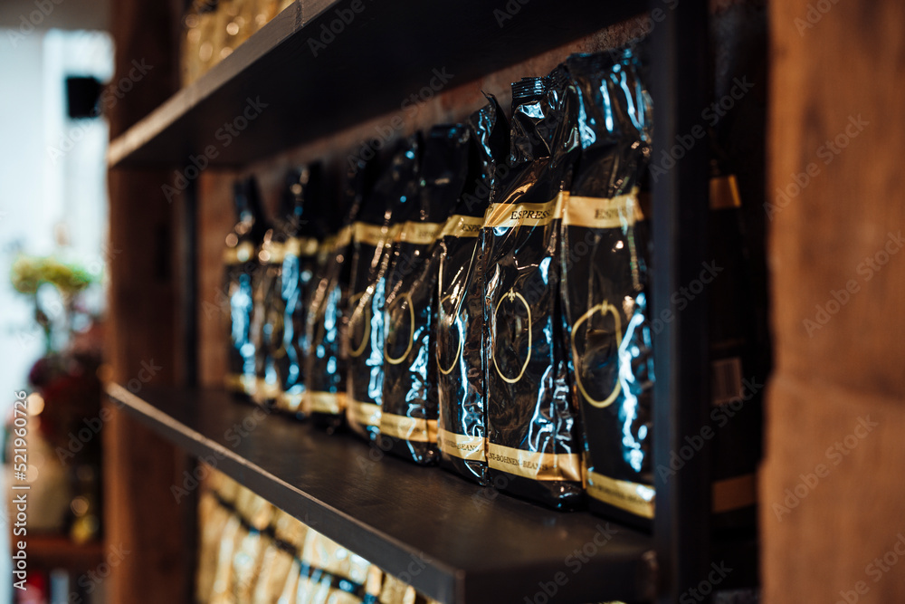Coffee packets arranged on rack at cafe Stock Photo | Adobe Stock