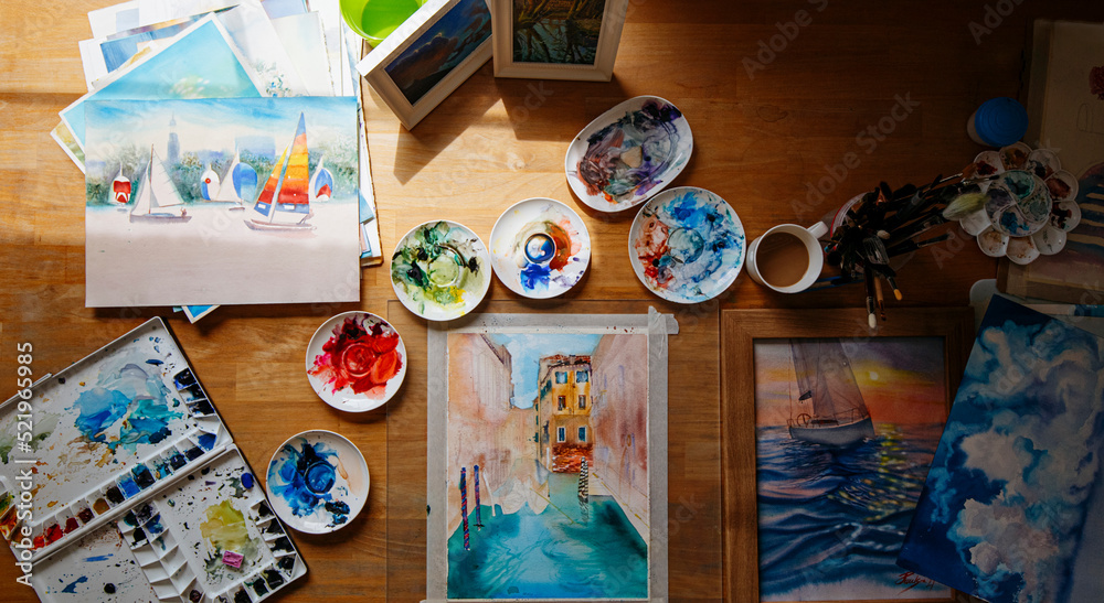 Watercolor painting and messy color palettes on table Stock Photo ...