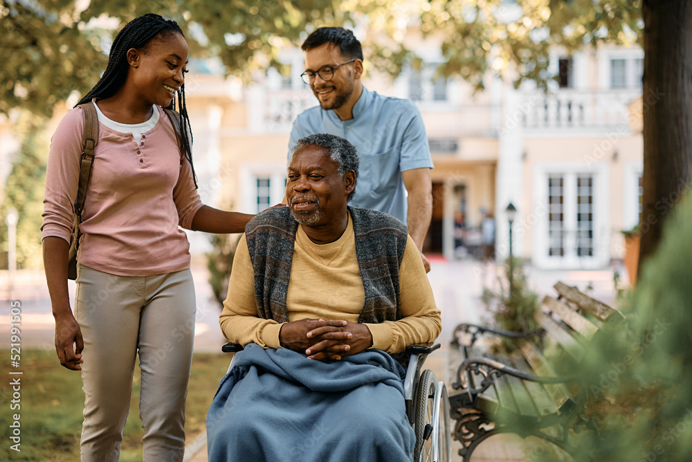 Poster Happy black woman visiting her senior father in nursing home ...