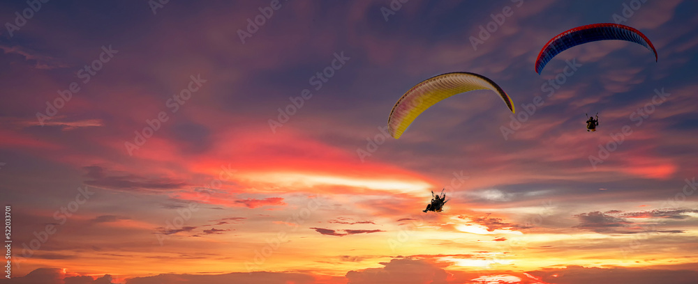 Skydiving sunset landscape of parachutist flying in soft focus. Para ...